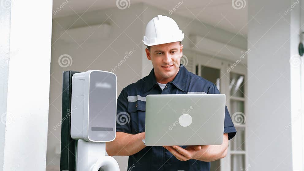 Qualified Technician Working with Laptop for Home EV Station ...