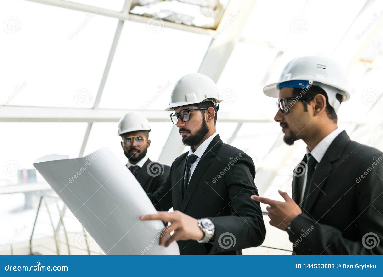 Qualified Young Indian Architects are Standing and Discussing Plan of ...