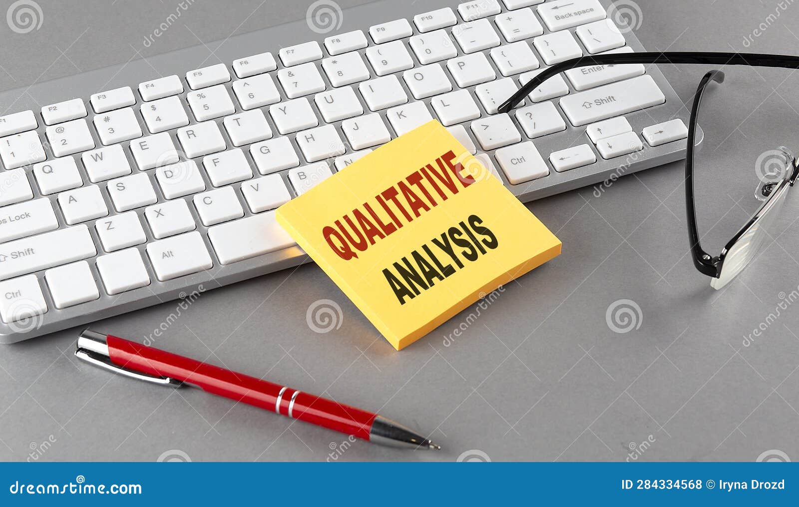QUALITATIVE ANALYSIS Text on a Sticky with Keyboard, Pen Glasses on ...