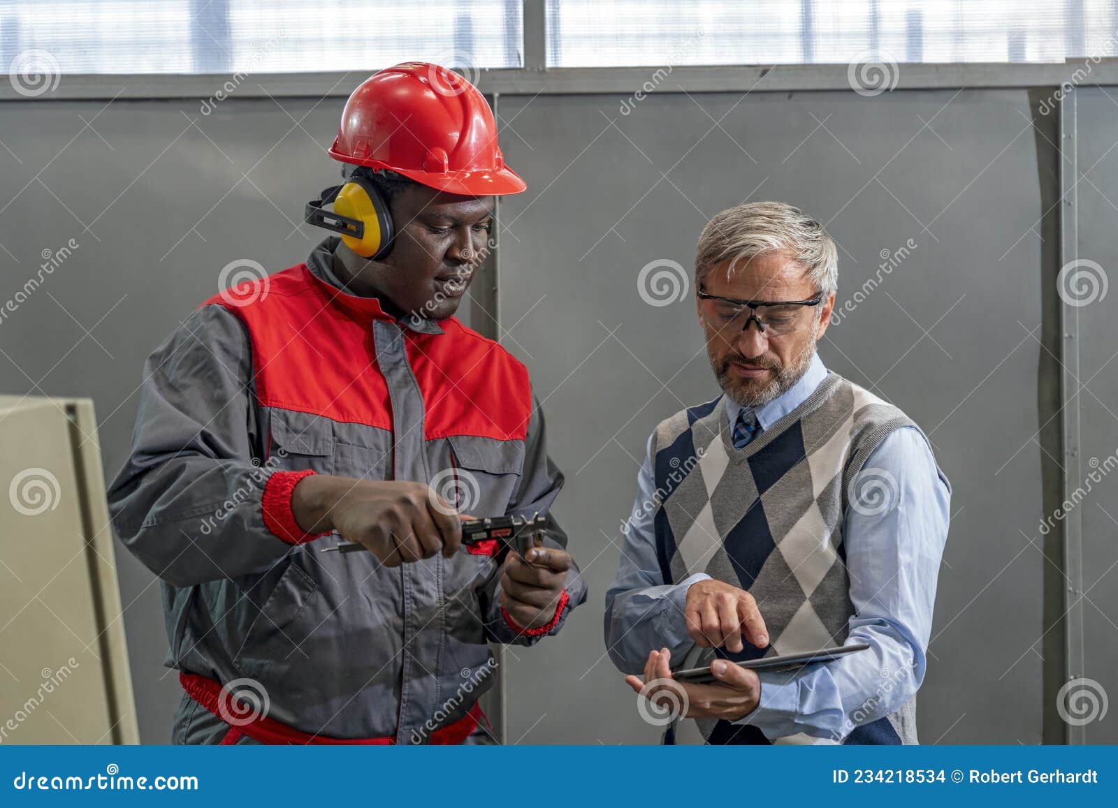Quality Control Inspector Using Digital Tablet and Talking To African ...