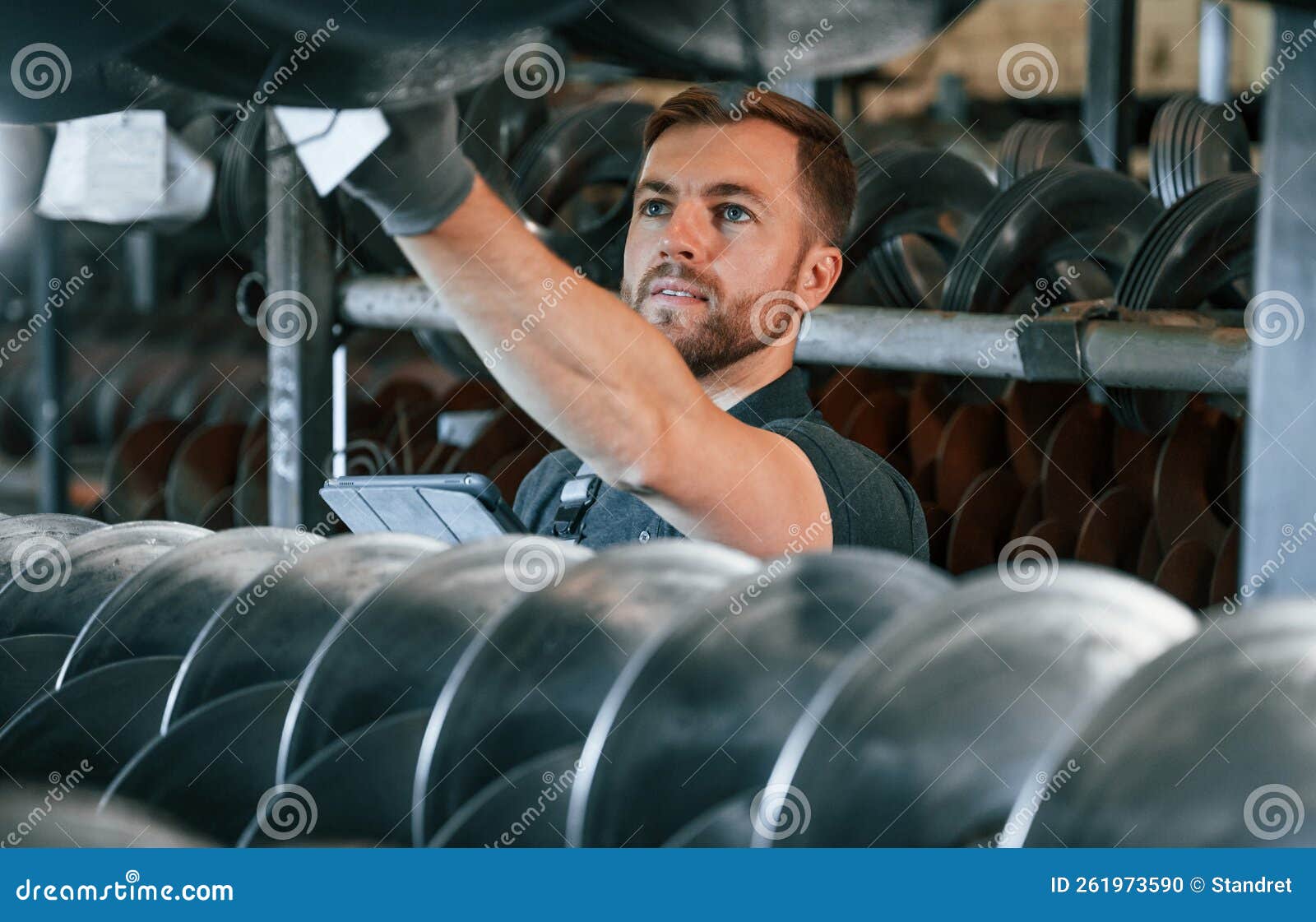 Quality Test. Man in Uniform is in Workstation Developing Details of ...
