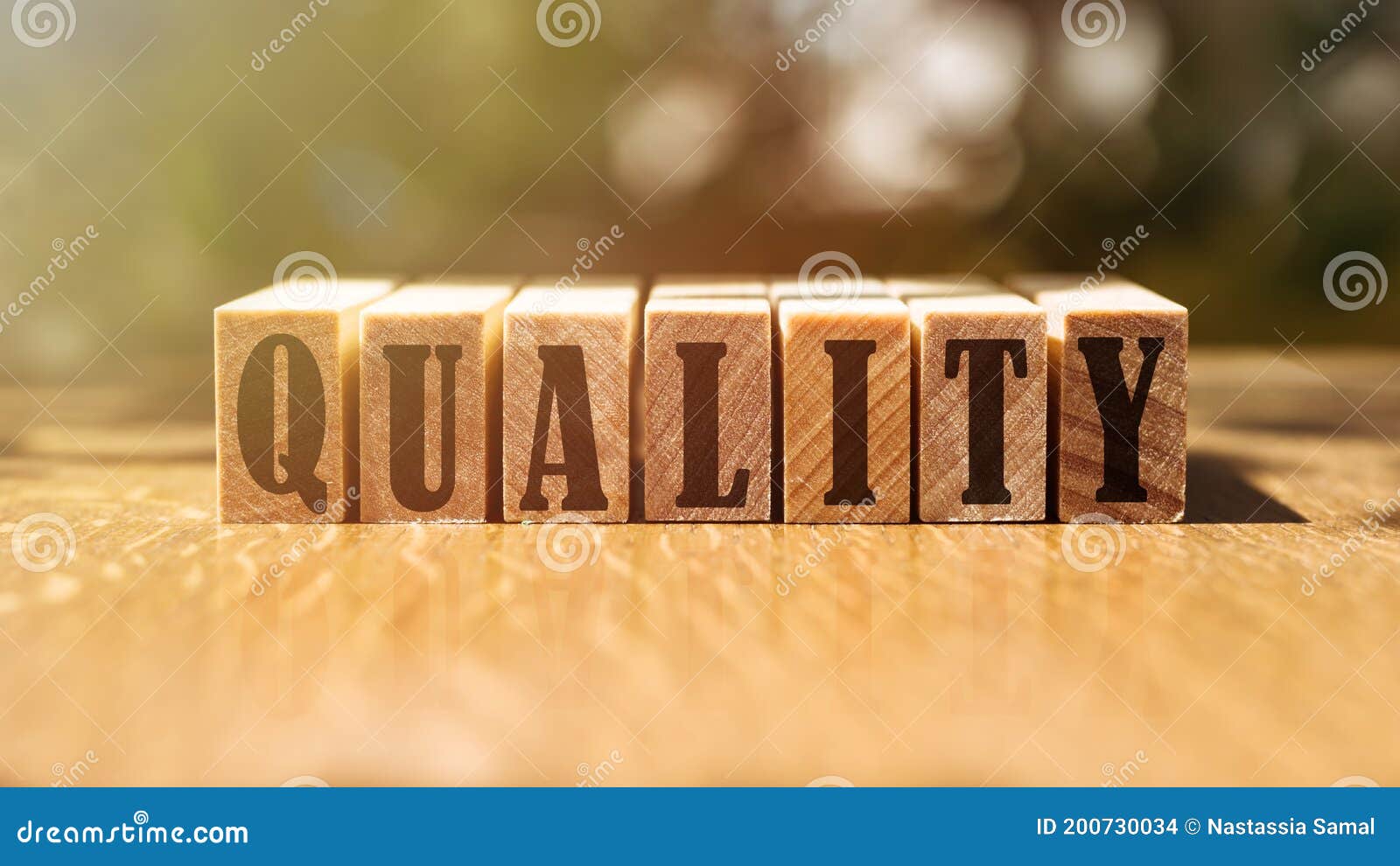 Quality Word Made with Building Wooden Blocks on Table in Sunlight ...