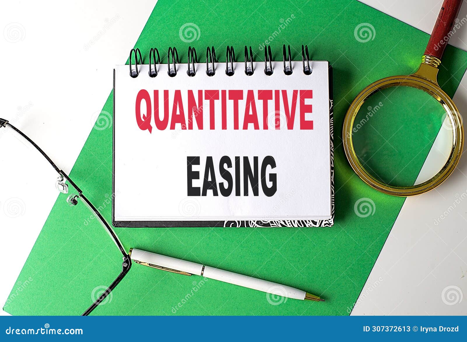 QUANTITATIVE EASING Text on Notebook on Green Paper Stock Image - Image ...