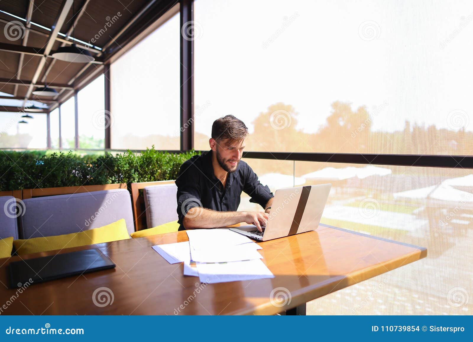 Quantity Surveyor Working at Cafe Table with Papers and Laptop. Stock ...