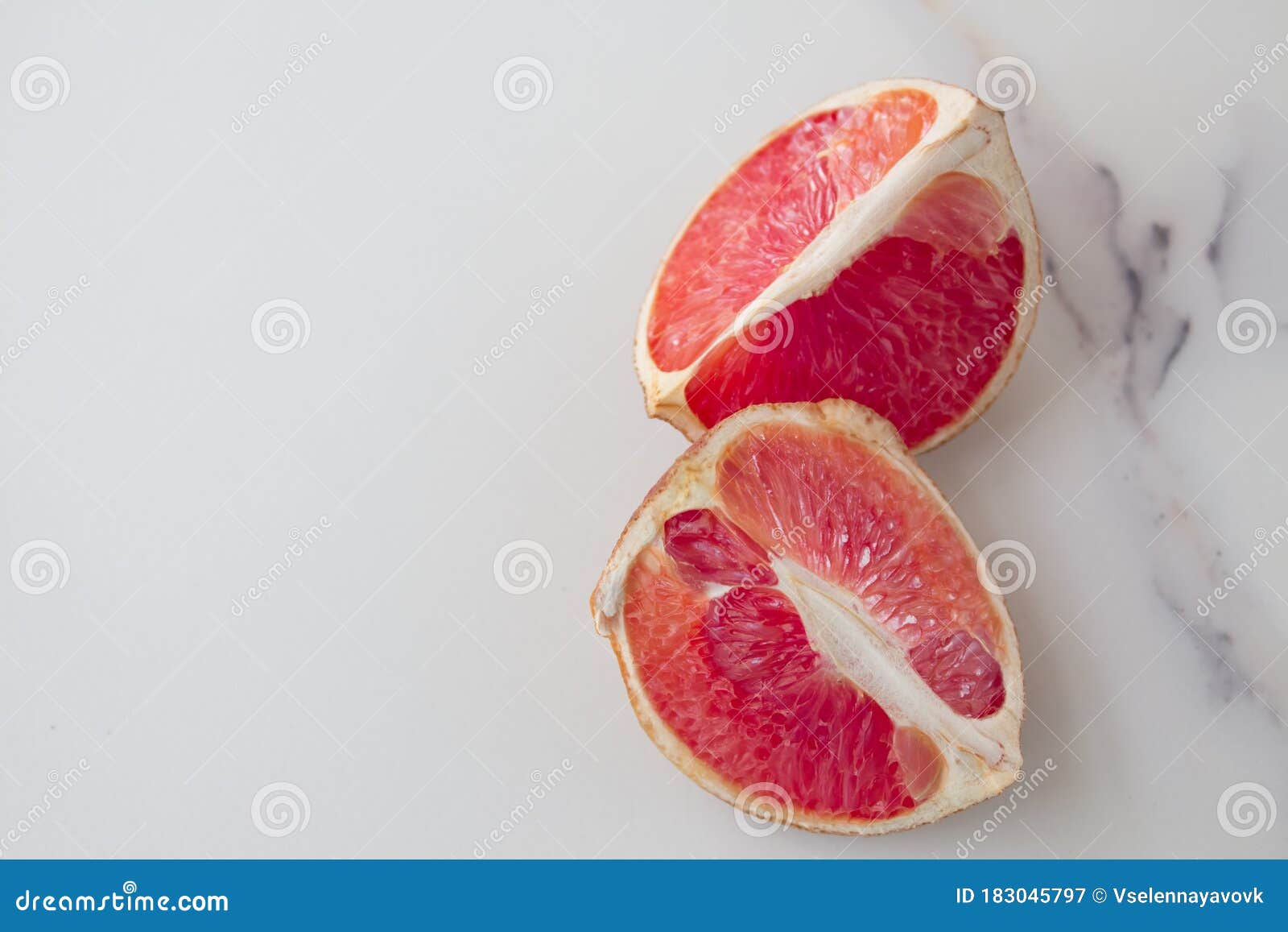 Quarters Flat Layout of Grapefruit Slices on Marble and Blue Loaf Close ...