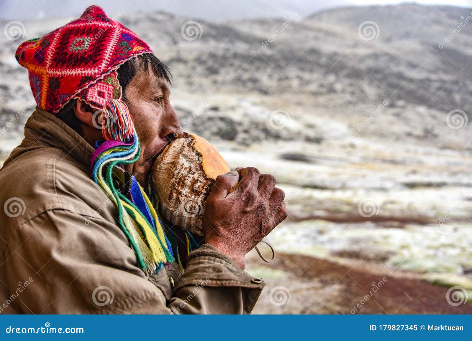 A Quechua Man Blows on a Pututu Conch Shell in the Andes Mountains Near ...
