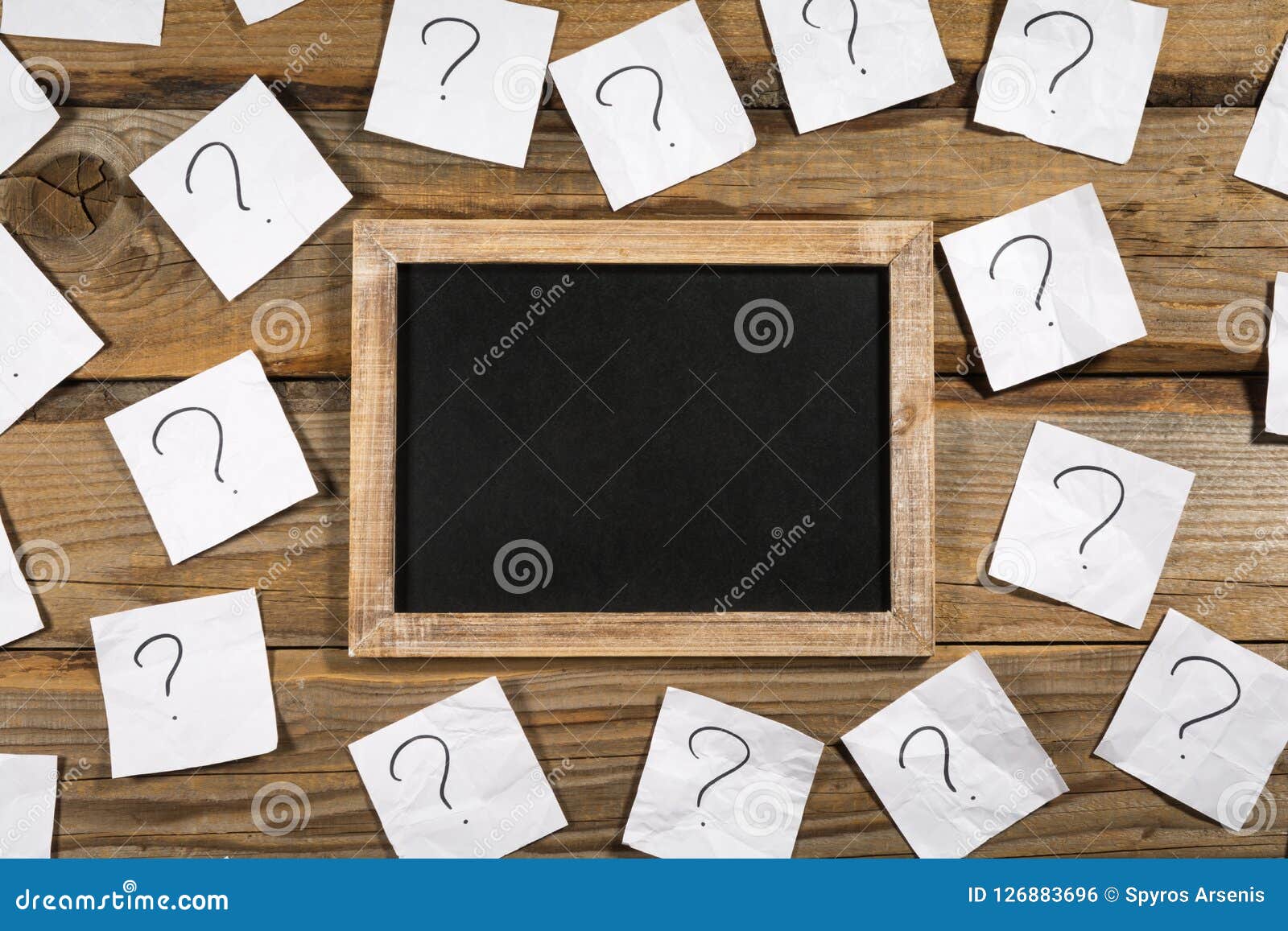 Question Marks on Crumpled Note Papers Around a Small Chalkboard Stock ...