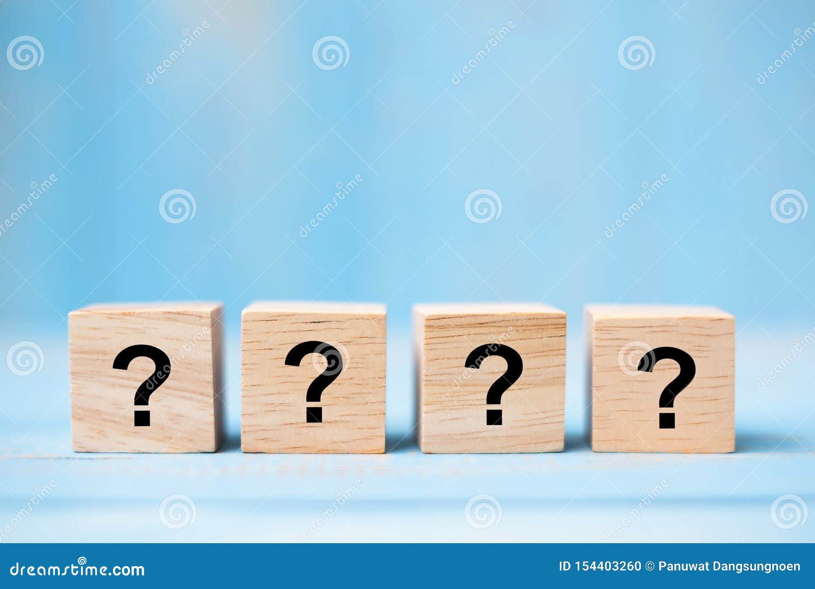Questions Mark ? Word with Wooden Cube Block on Blue Table Background ...