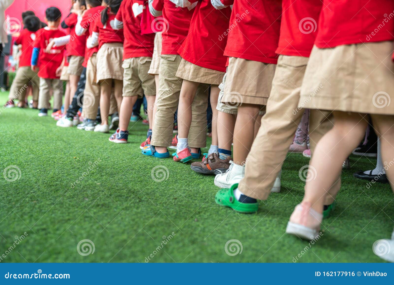 Queue of Asian Kids in School Uniform Standing in Line Stock Photo ...