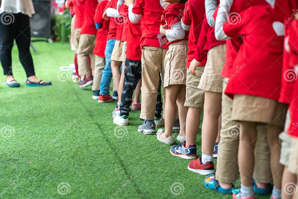 Queue of Asian Kids in School Uniform Standing in Line Stock Photo ...