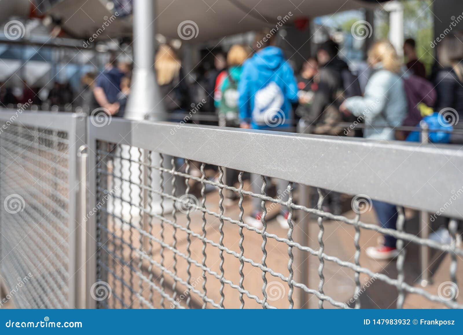 Queue in a Park with a Security Fence Stock Photo - Image of blur ...