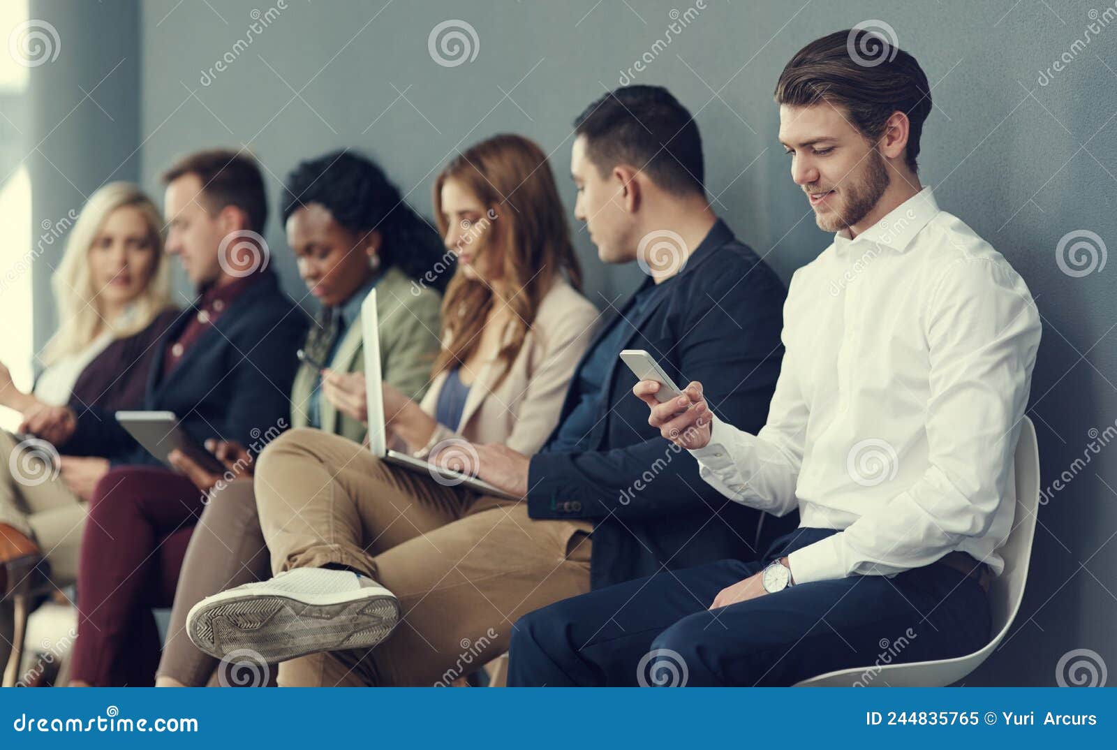 The Queue To Success. Shot of a Group of Businesspeople Using Different ...