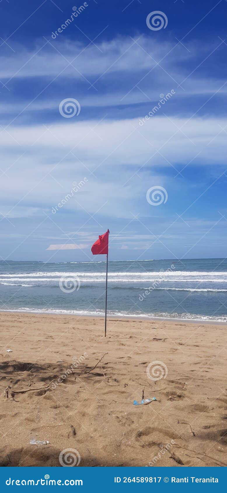 Quiet Beach with Red Flag and Blue Sky Stock Image - Image of beach ...