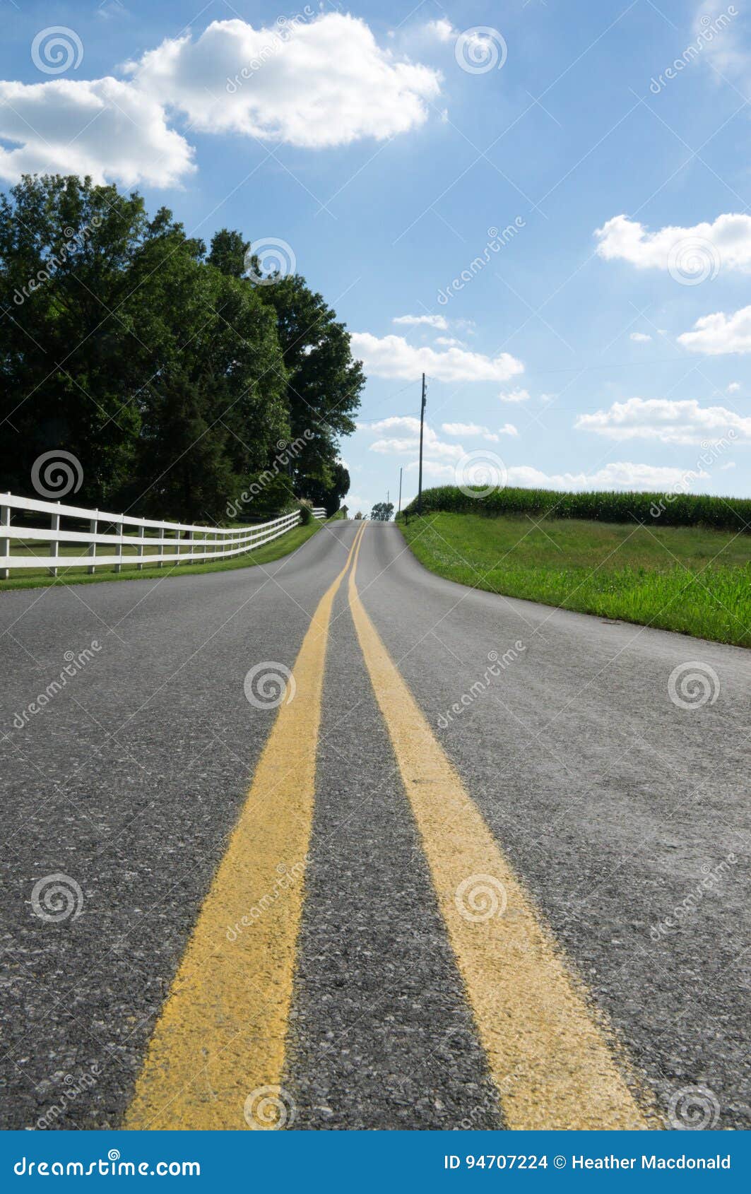 Quiet Country Road In A Slope Stock Photo | CartoonDealer.com #196894320