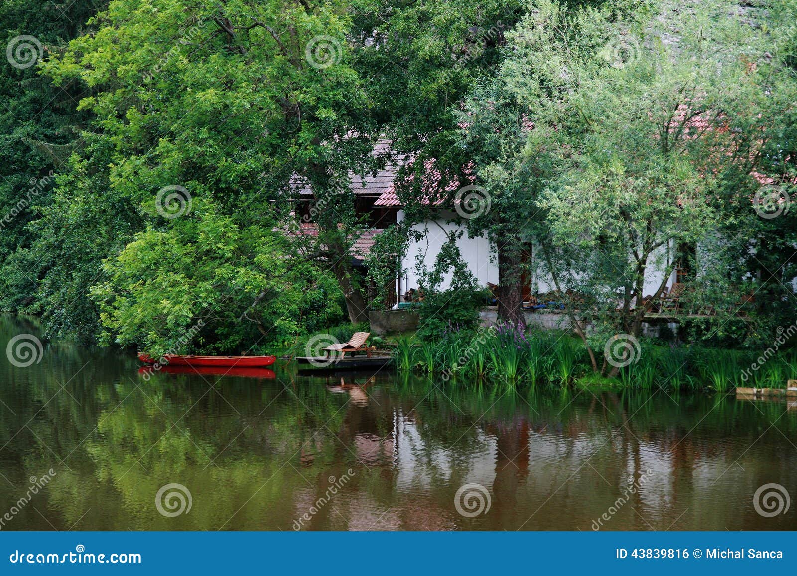 Quiet Place on the Water with a Red Boat, Cottage and Trees in Stock ...