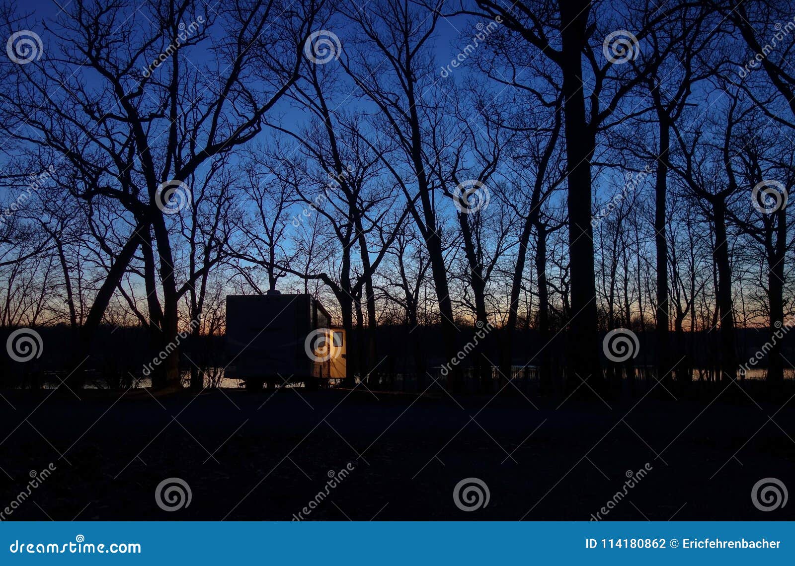 Quiet Scene of a Camper in the Forest at Dusk. Stock Photo - Image of ...