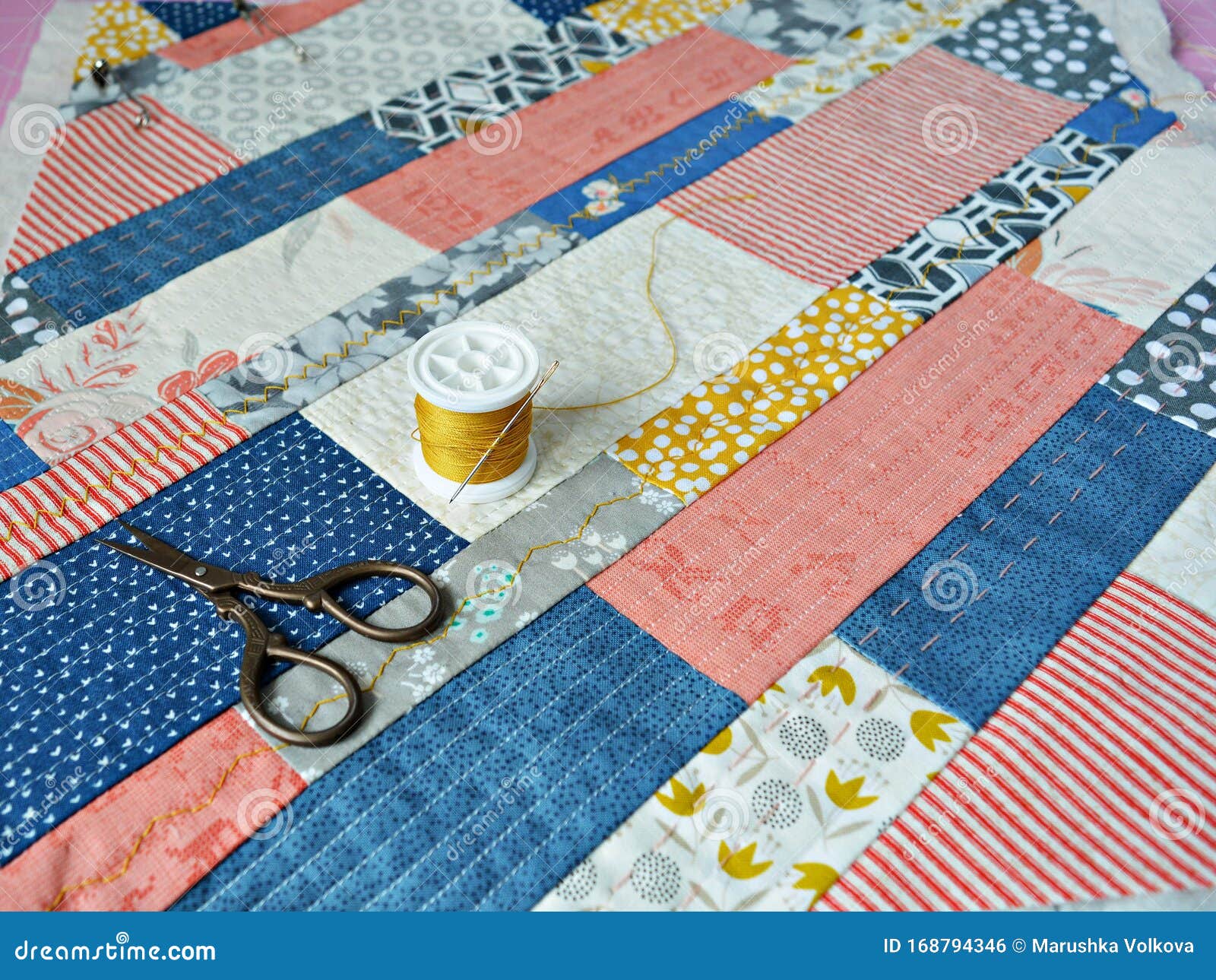 Quilting Process: Mustard Thread Spool, Needle and Scissors Stock Photo ...