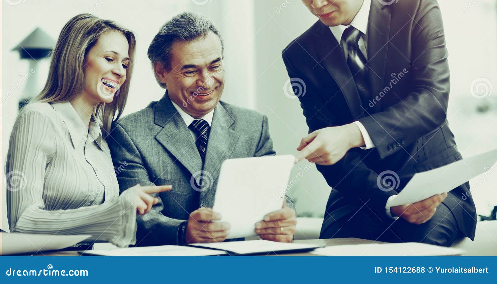 Successful Business Team Discussing Work Plan Using a Tablet Photo ...