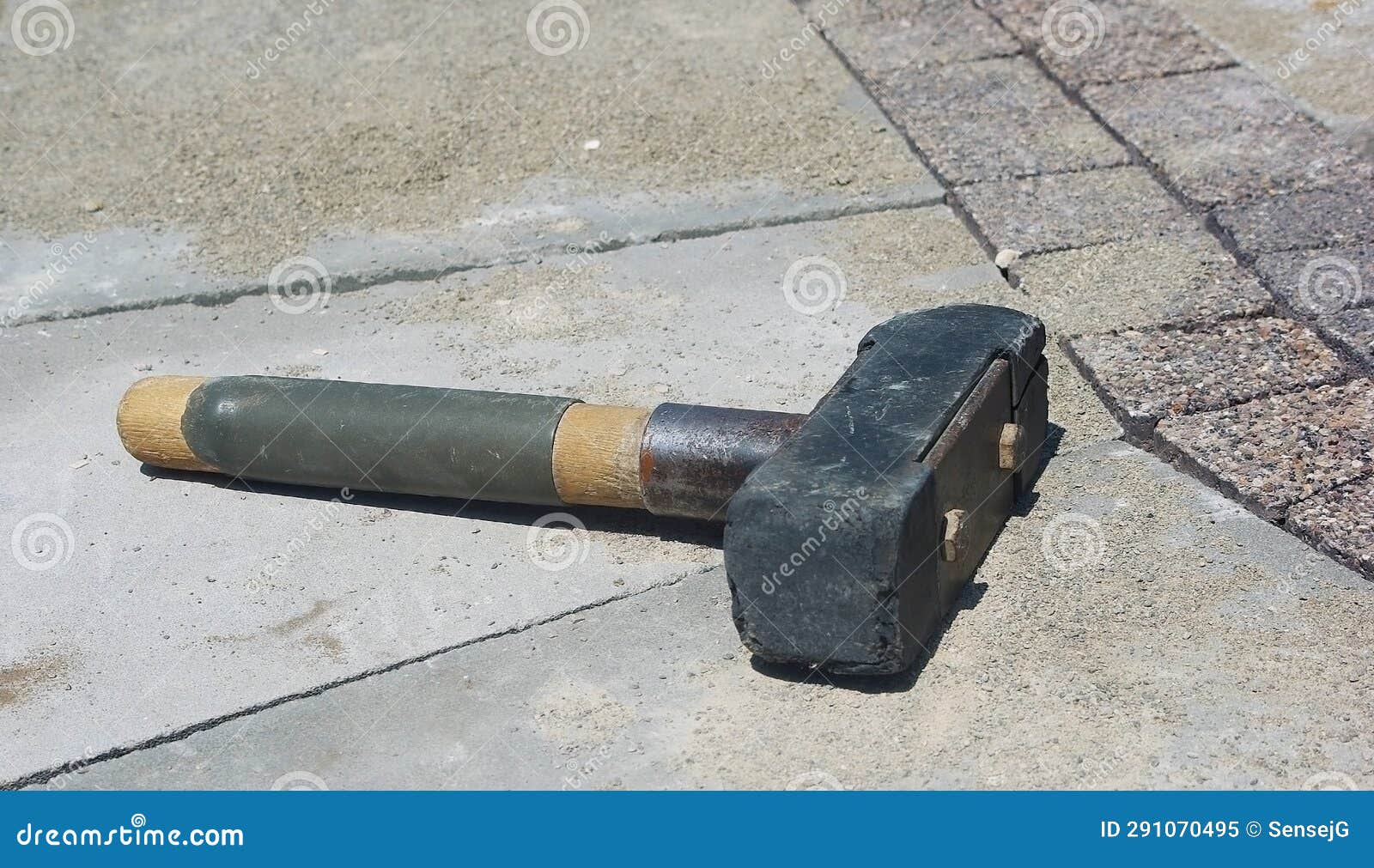 A Quite Worn-out Rubber Paving Hammer Lying on a Freshly Paved Surface ...
