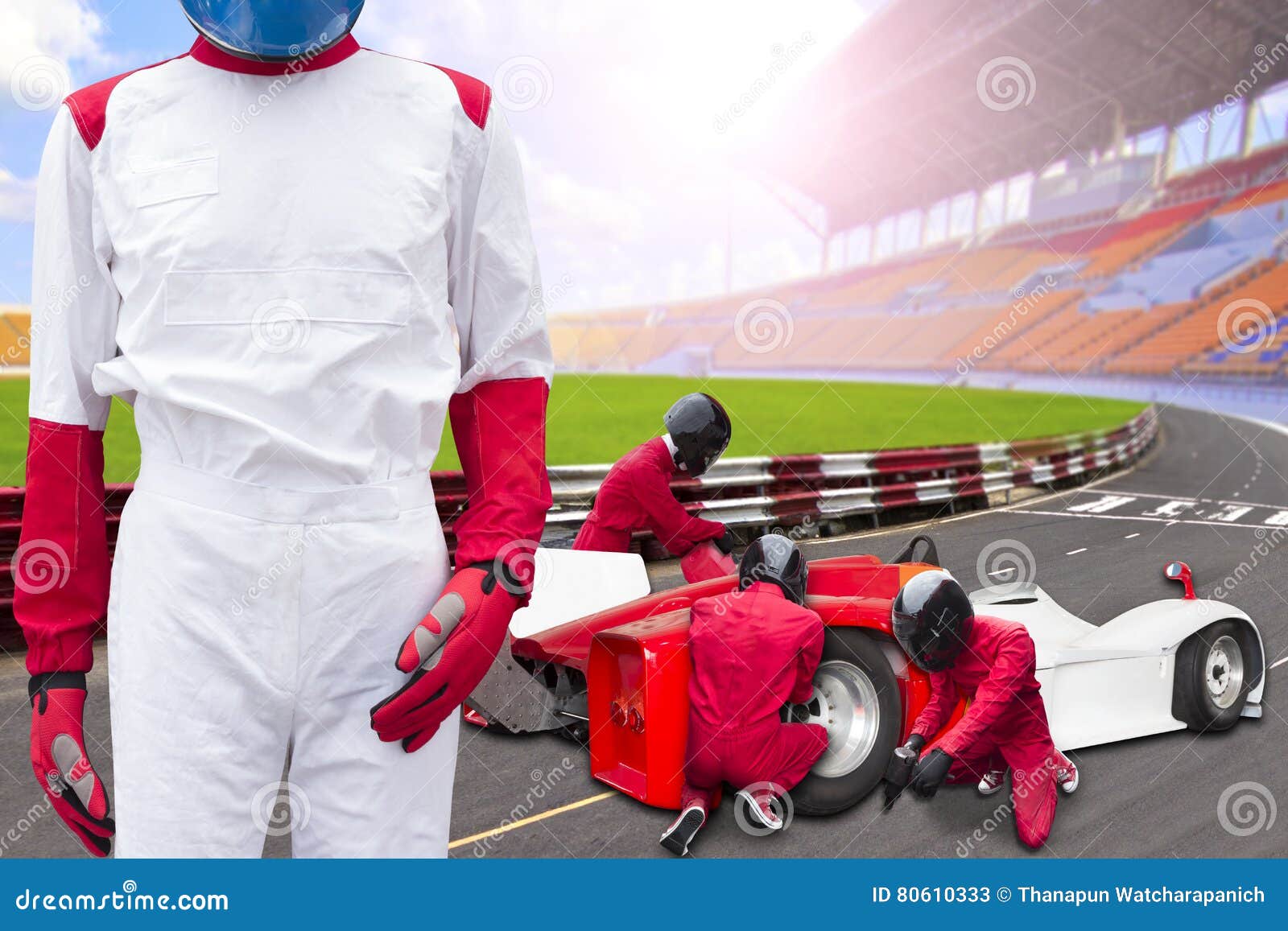 Race Car Driver Posing in Front of the Pit Stop with Team Maintaining ...