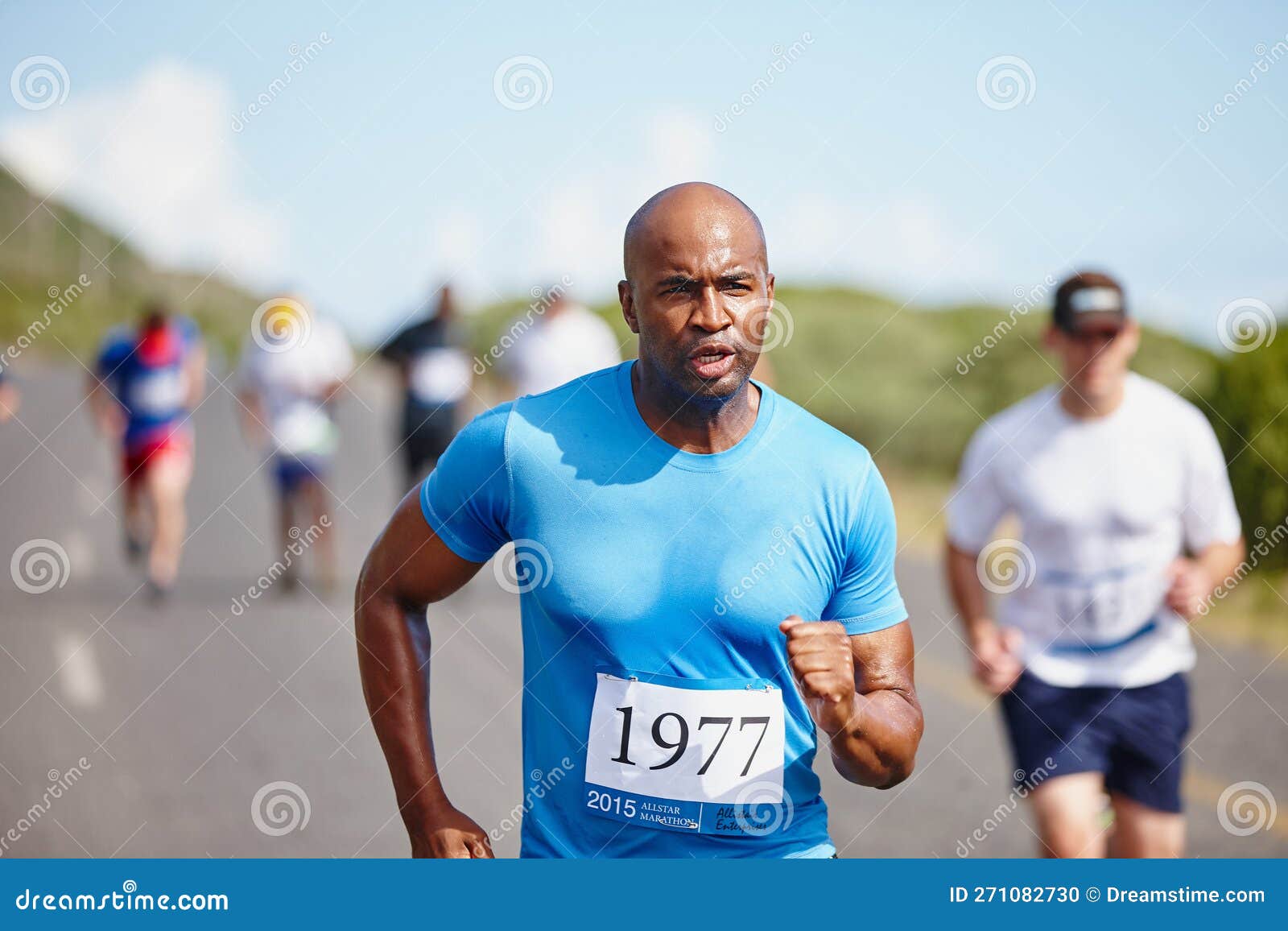 The Race is on. a Young Man Running Ahead of the Pack in a Marathon ...