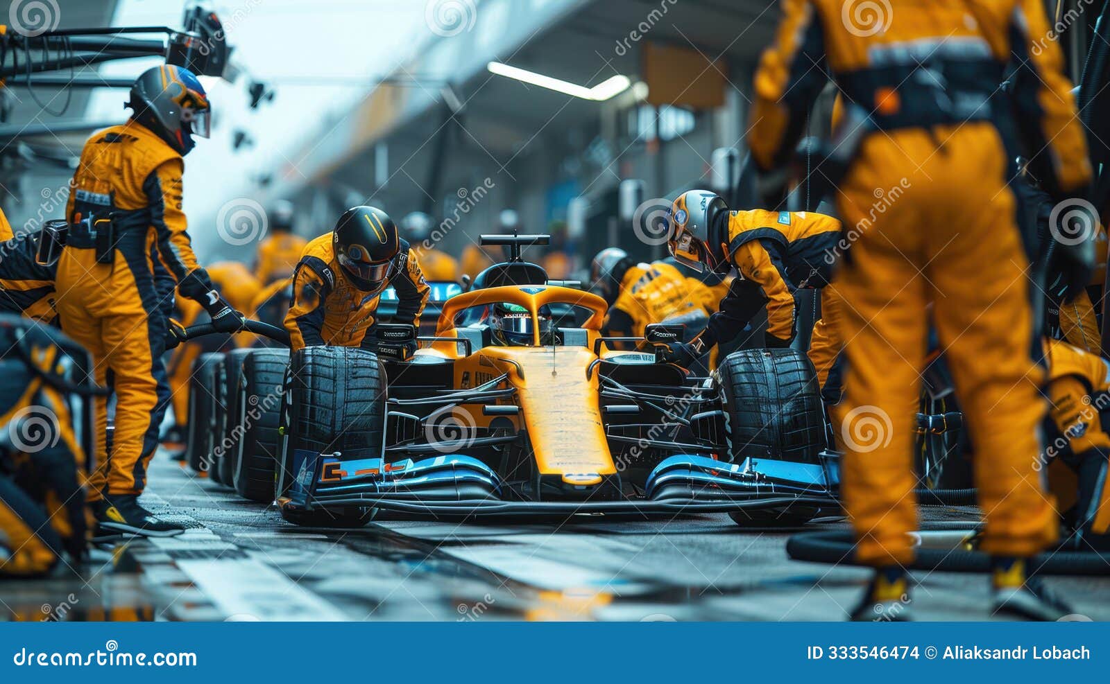 The Racing Team is Working on the Pit Stop. a Racing Car Goes through a ...