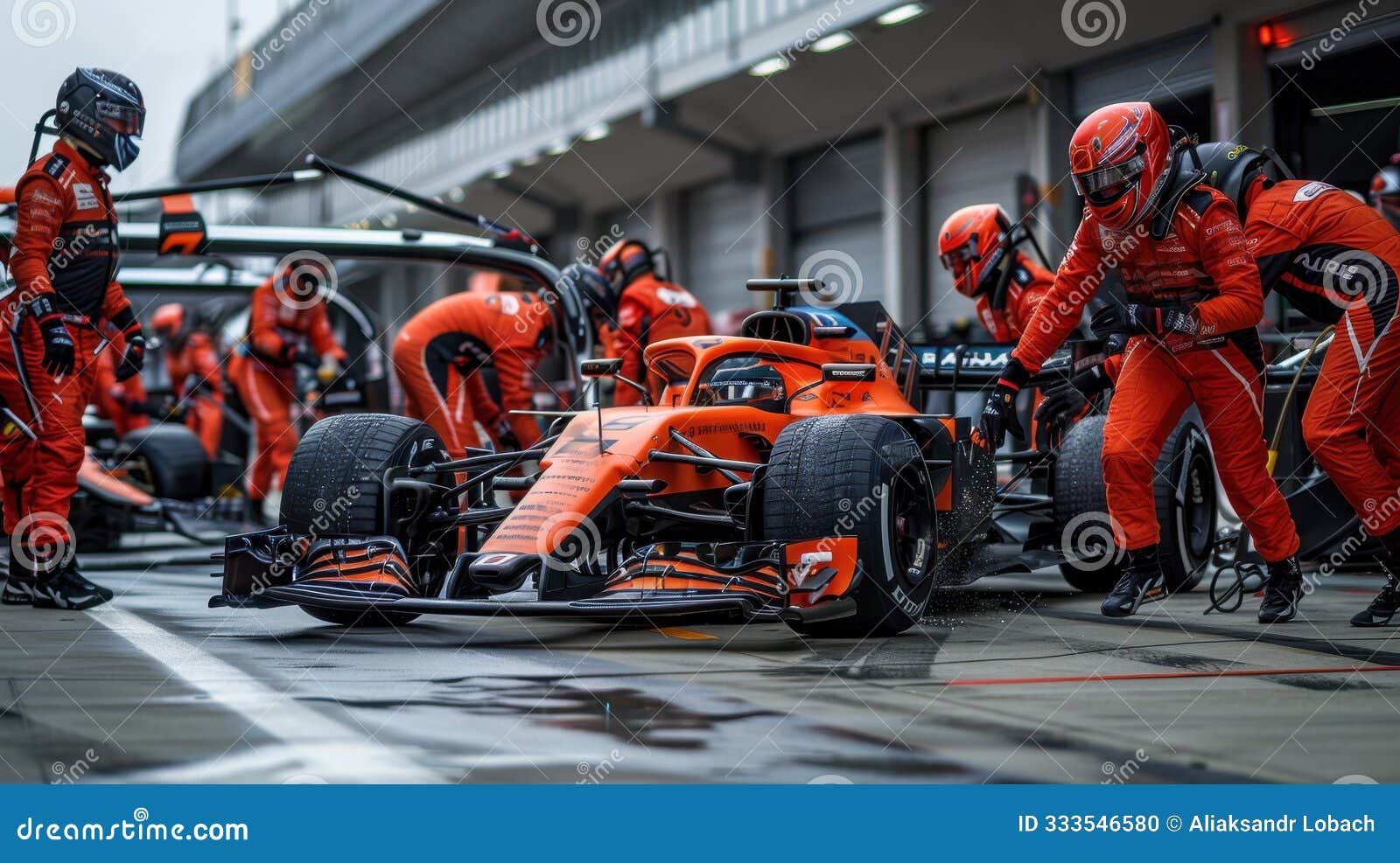 The Racing Team is Working on the Pit Stop. a Racing Car Goes through a ...