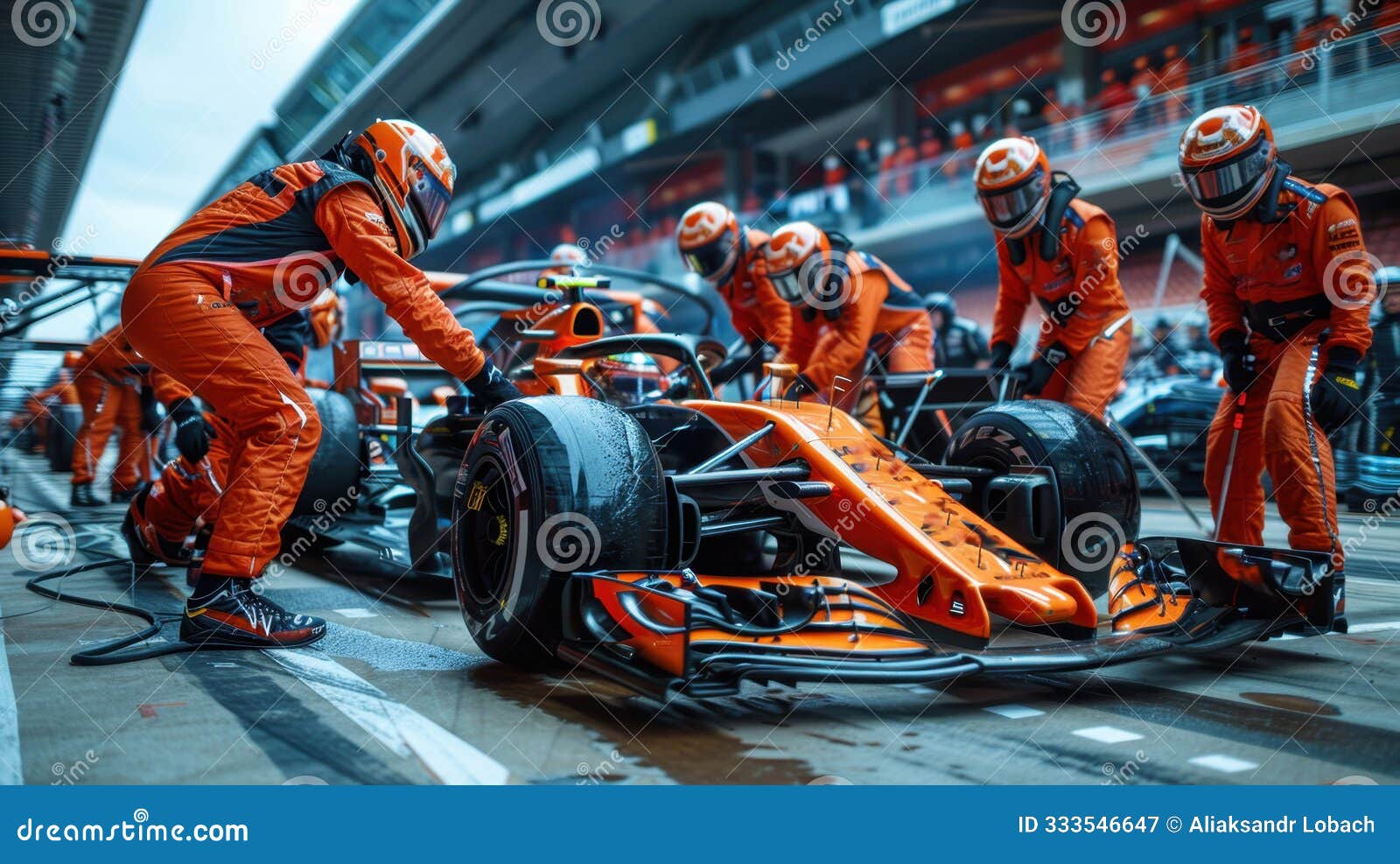 The Racing Team is Working on the Pit Stop. a Racing Car Goes through a ...