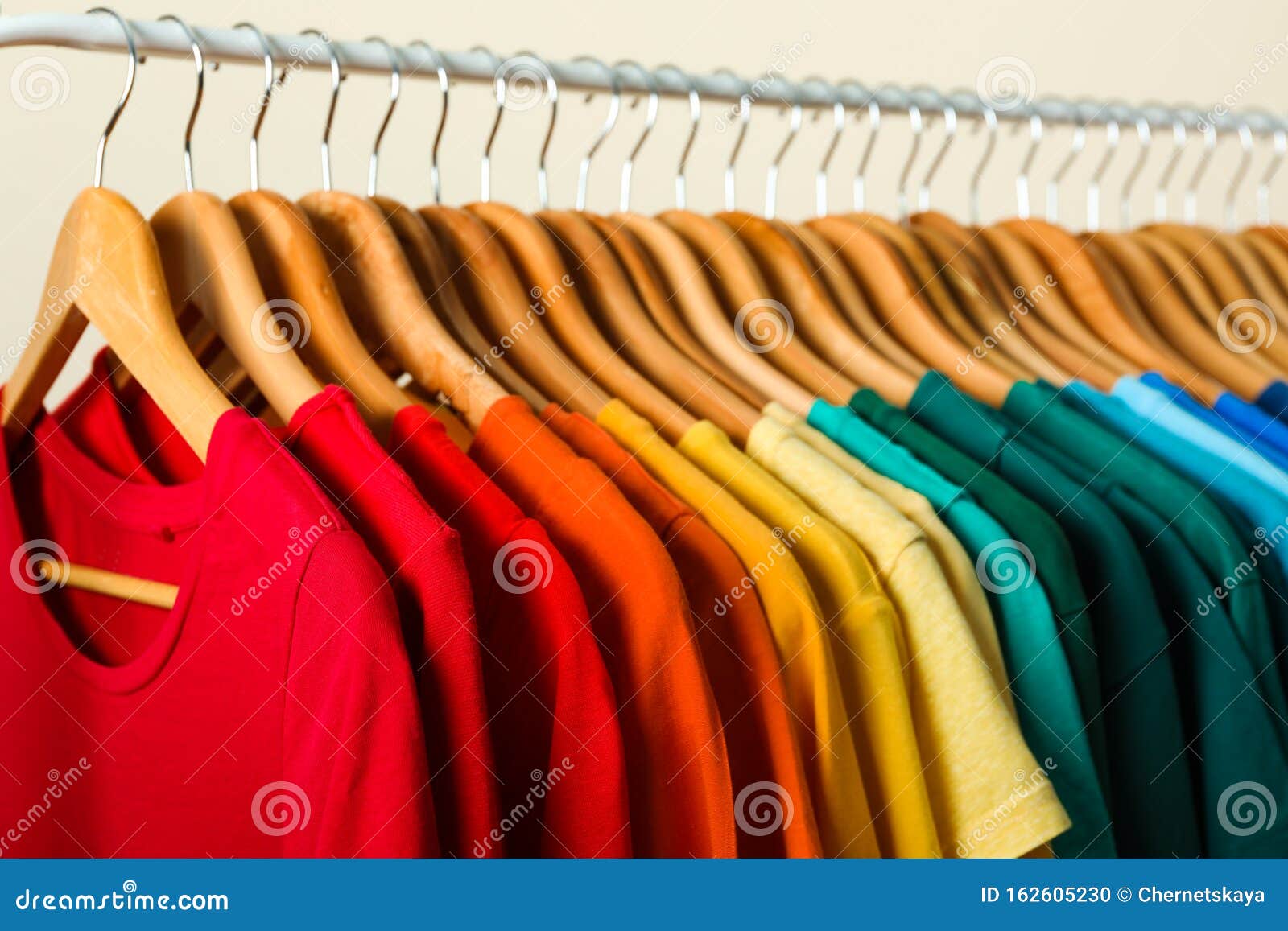 Rack with Bright Clothes on Background. Rainbow Colors Stock Photo ...