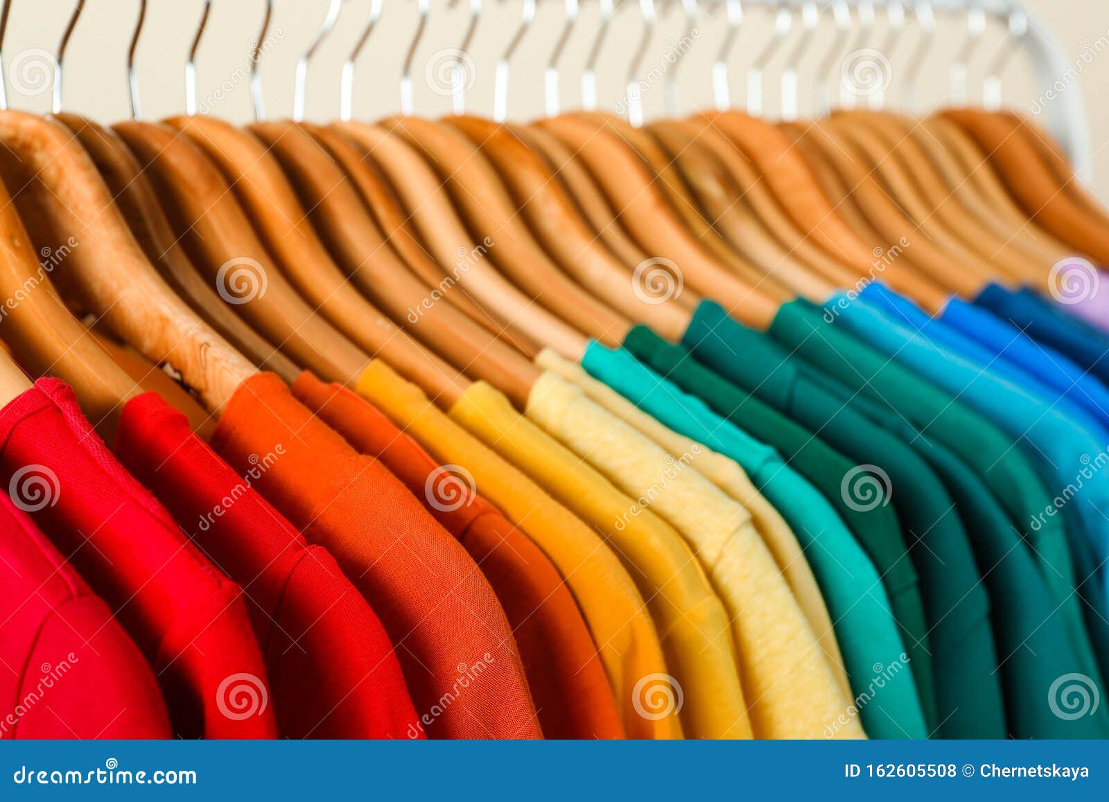 Rack with Bright Clothes on Background. Rainbow Colors Stock Photo ...