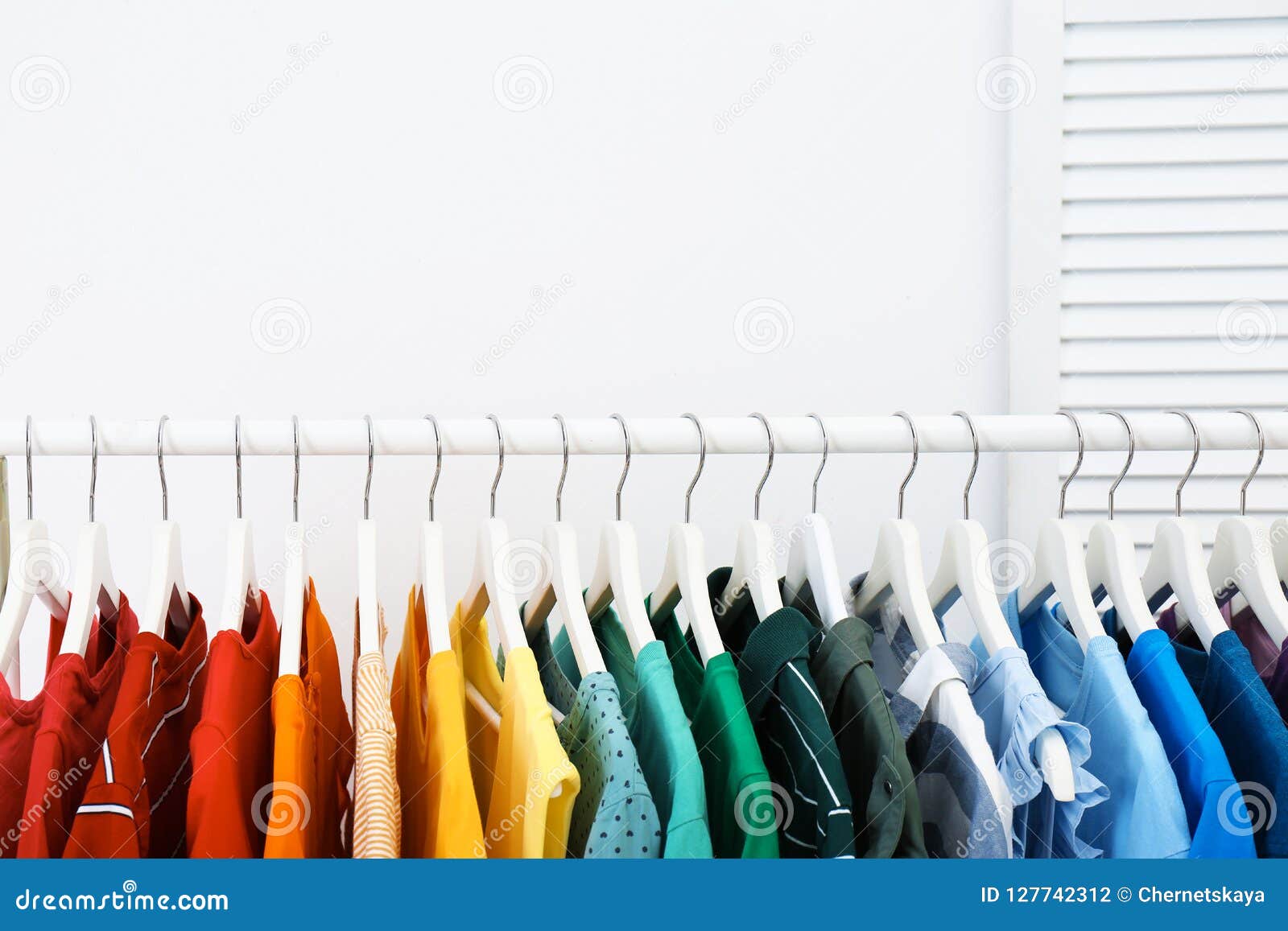 Rack with Bright Clothes in Room Stock Photo - Image of room, color ...