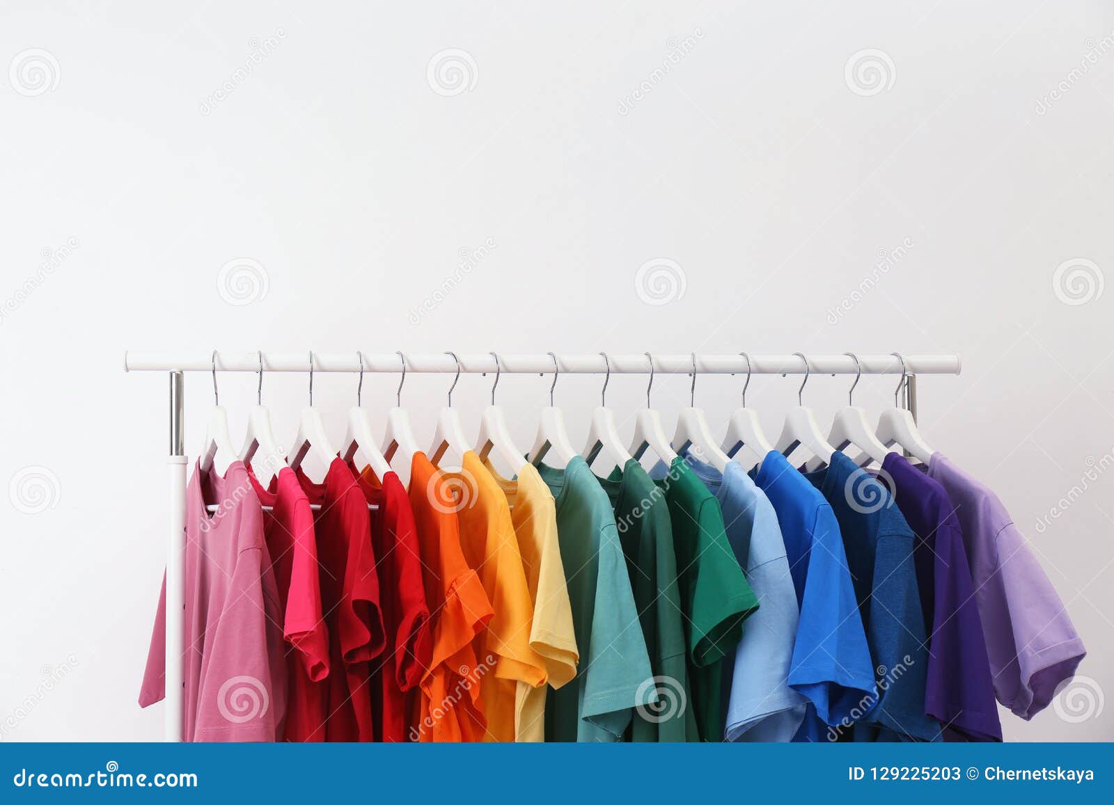 Rack with Bright Clothes on White Background. Stock Image - Image of ...