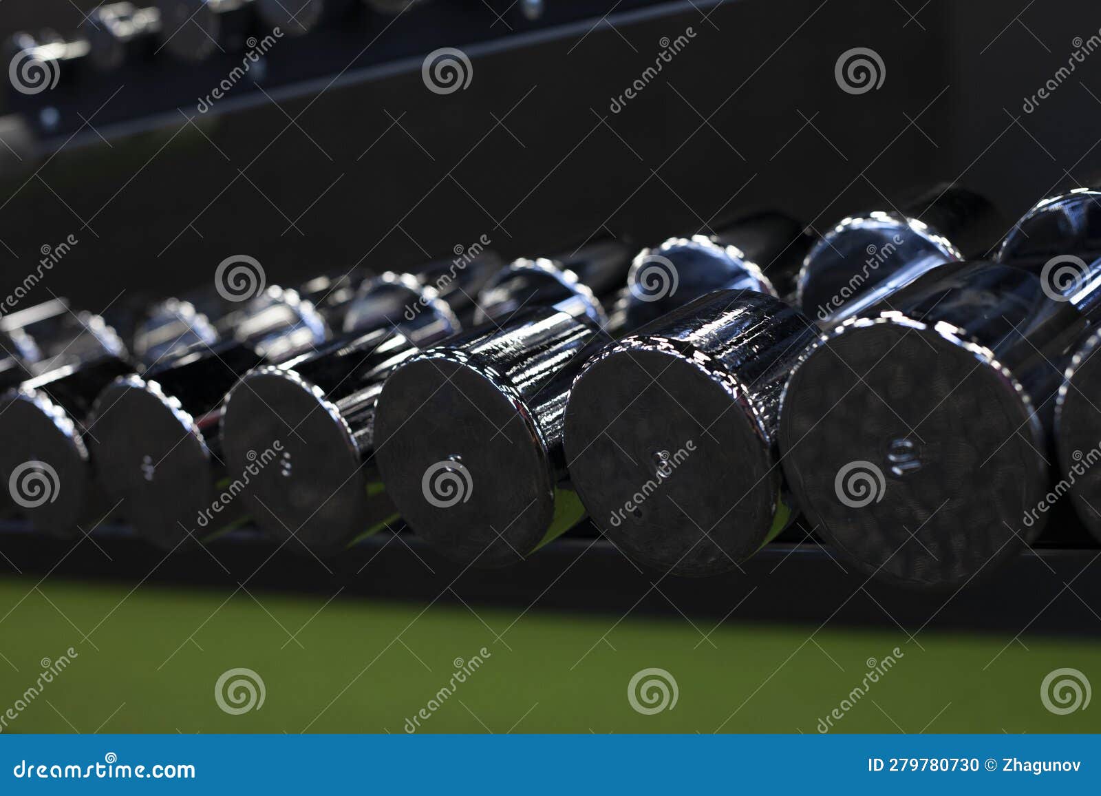Rack with chrome dumbbells stock photo. Image of lift - 279780730