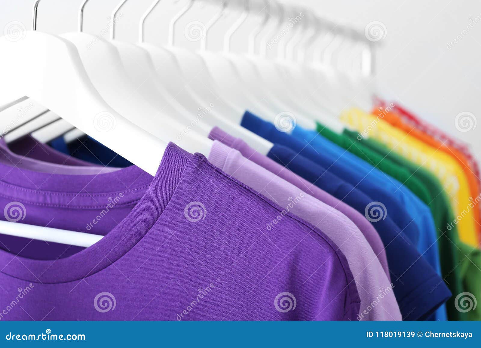 Rack with Rainbow Clothes on Light Background Stock Image - Image of ...