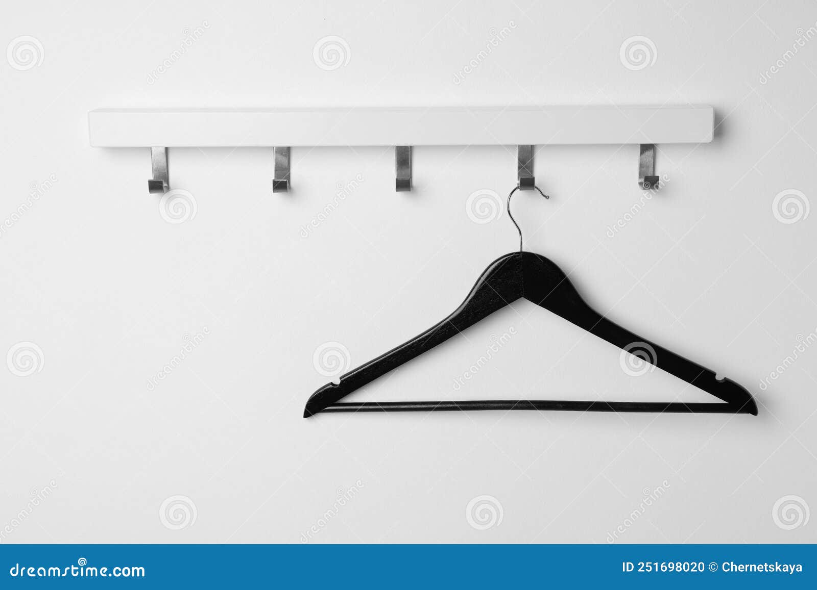Rack with Empty Black Clothes Hanger on White Wall Stock Photo - Image ...