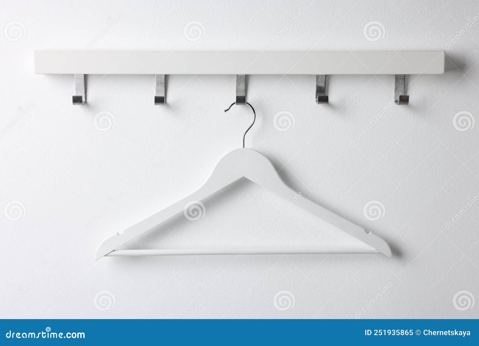 Rack with Empty Clothes Hanger on White Wall Stock Image - Image of ...
