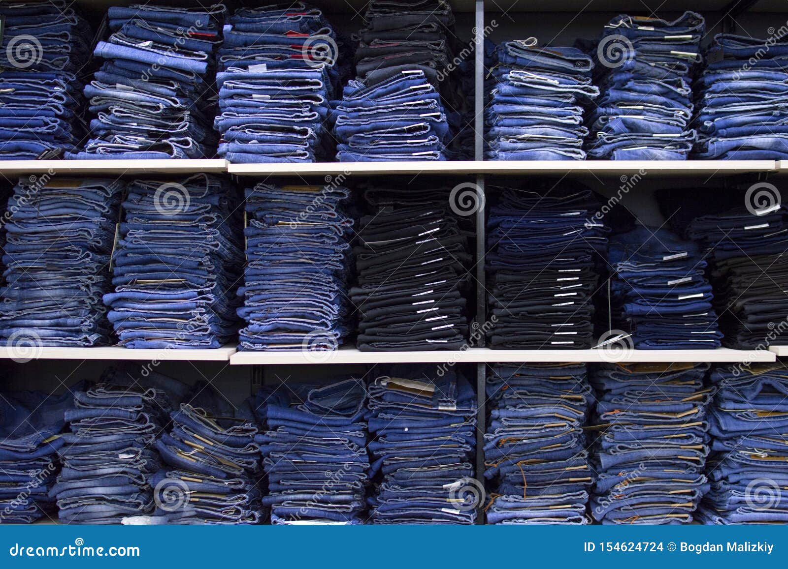 Rack with Folded Jeans, a Lot of Jeans, Lying on a Shelf in the Store ...