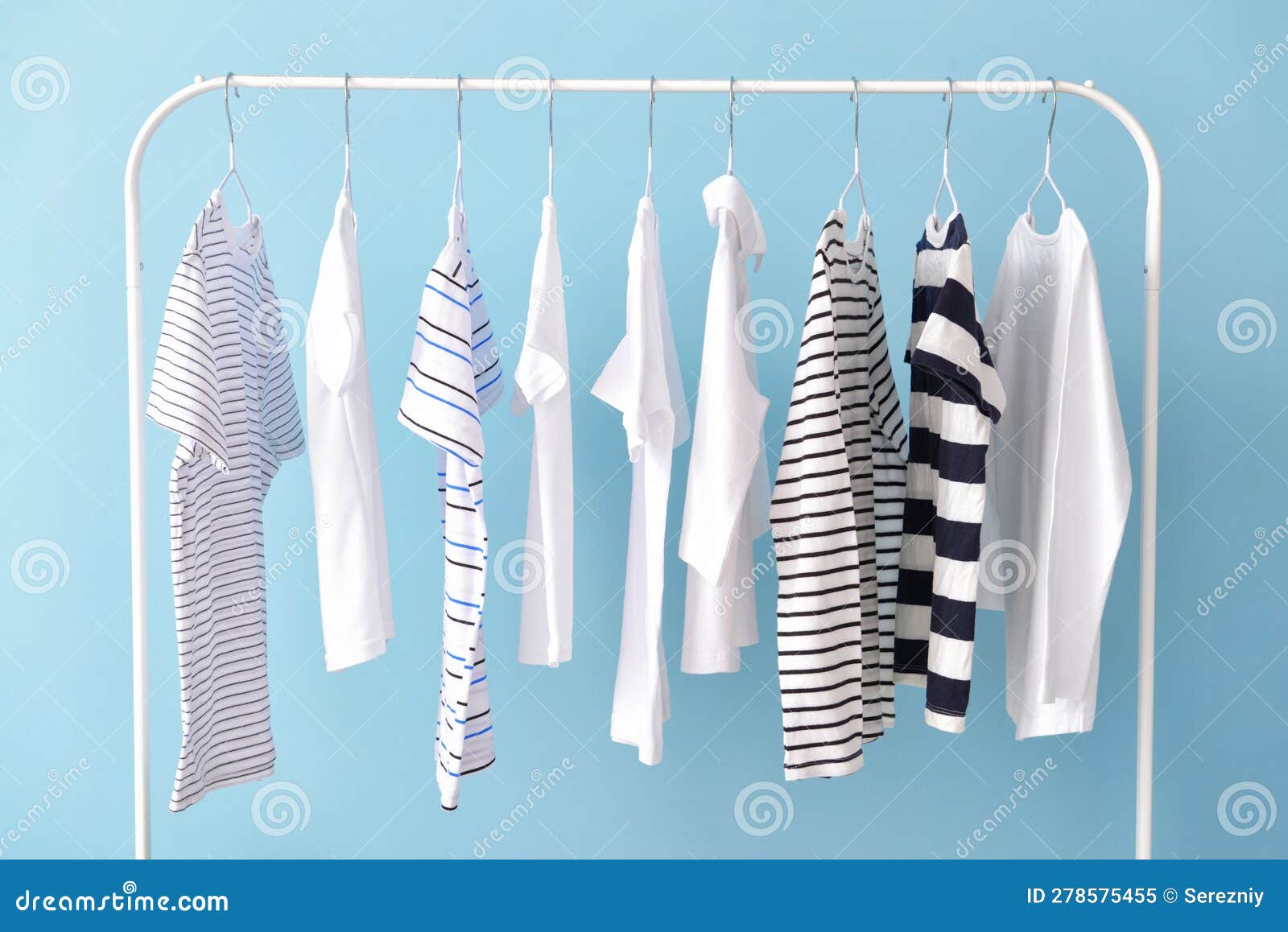 Rack with Hanging Clothes on Color Background Stock Image - Image of ...
