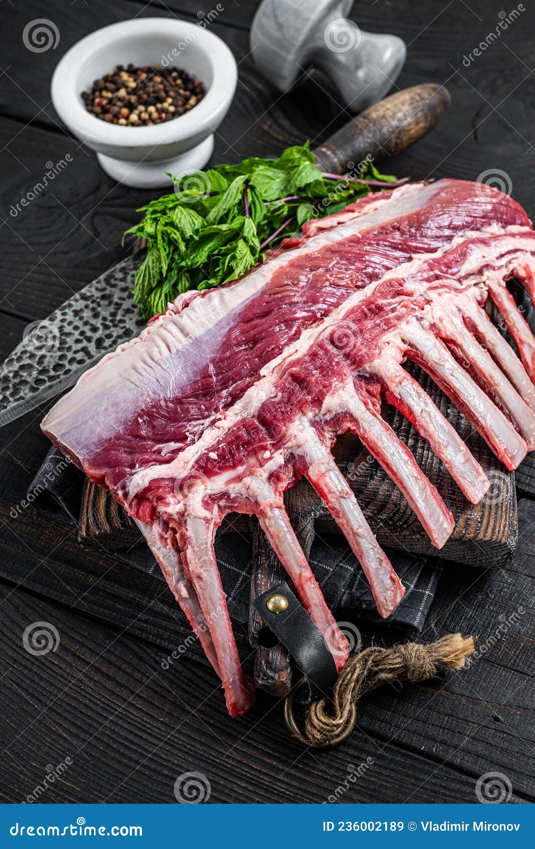 Rack of Lamb Ready for Cooking on a Butcher Cutting Board. Black ...