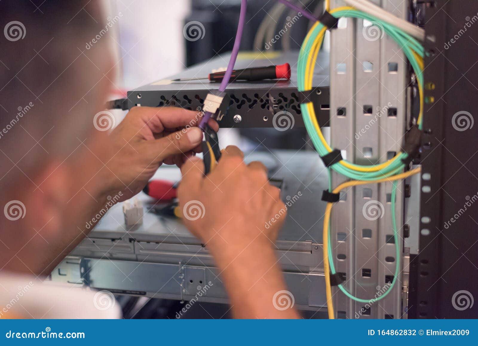 Rack Mounted Servers in a Server Room, Man Work with Lan or Network ...