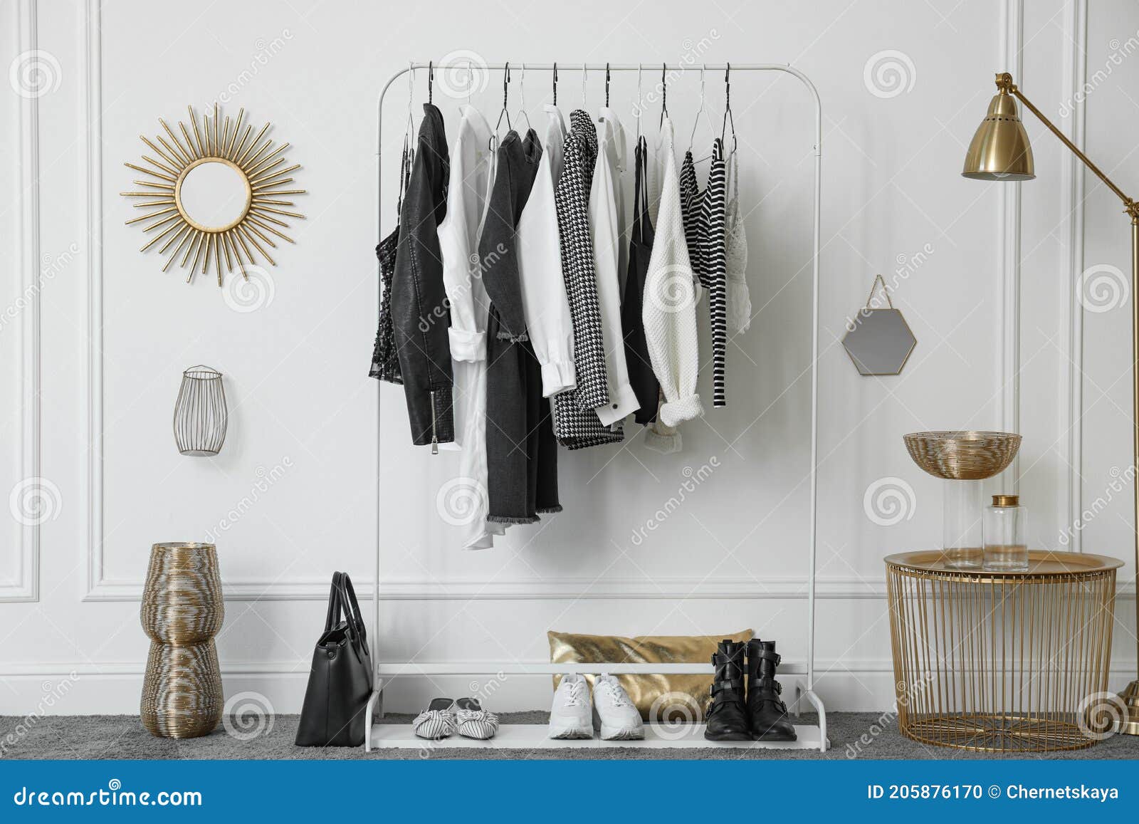 Rack with Stylish Clothes Near White Wall in Dressing Room Stock Photo ...