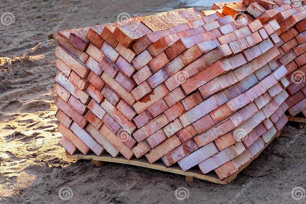 Racks with Full-bodied Bricks. Several Pallets of Red Bricks are ...
