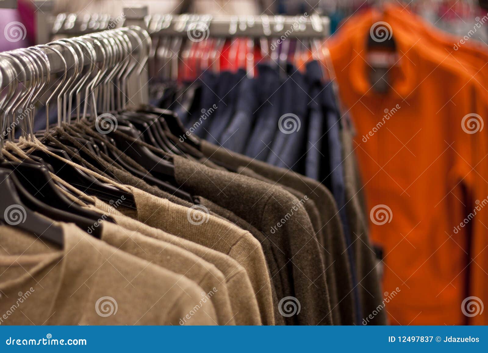 Racks of Sweaters and Shirts Hanging in a Store Stock Image - Image of ...