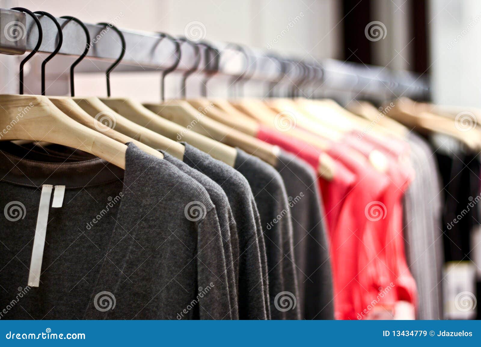 Racks of Sweaters and Shirts Hanging in a Store Stock Image - Image of ...