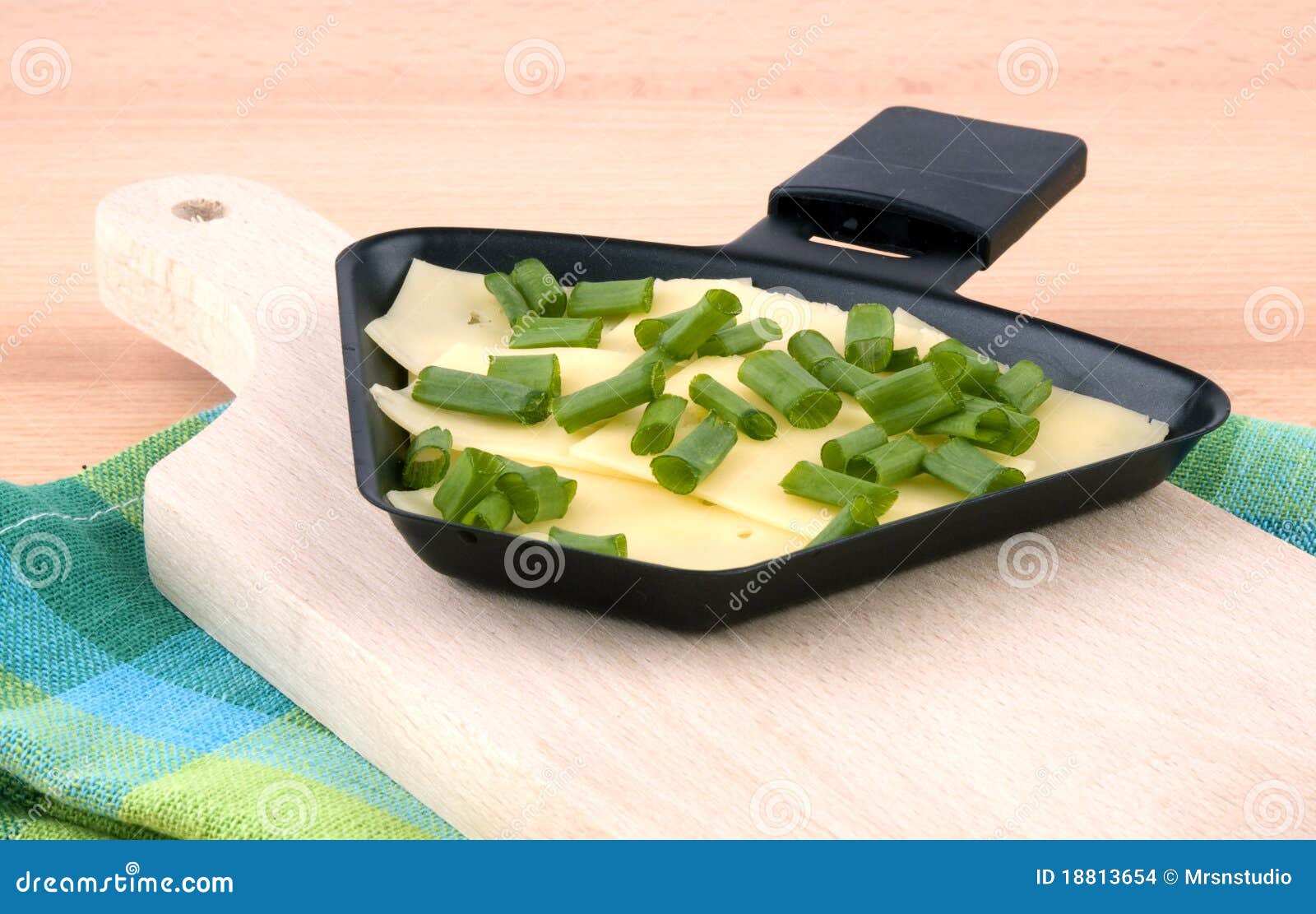 Raclette Pan with Cheese and Spring Onion Stock Photo - Image of grill ...