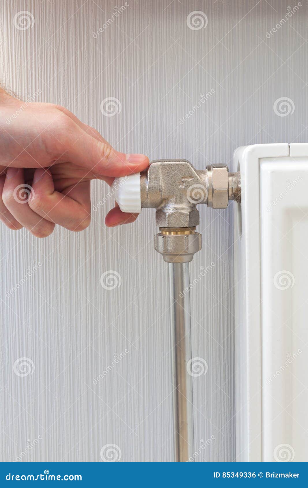 Radiator Adjustment Closeup. Man`s Hand Adjusting Radiator Temperature ...