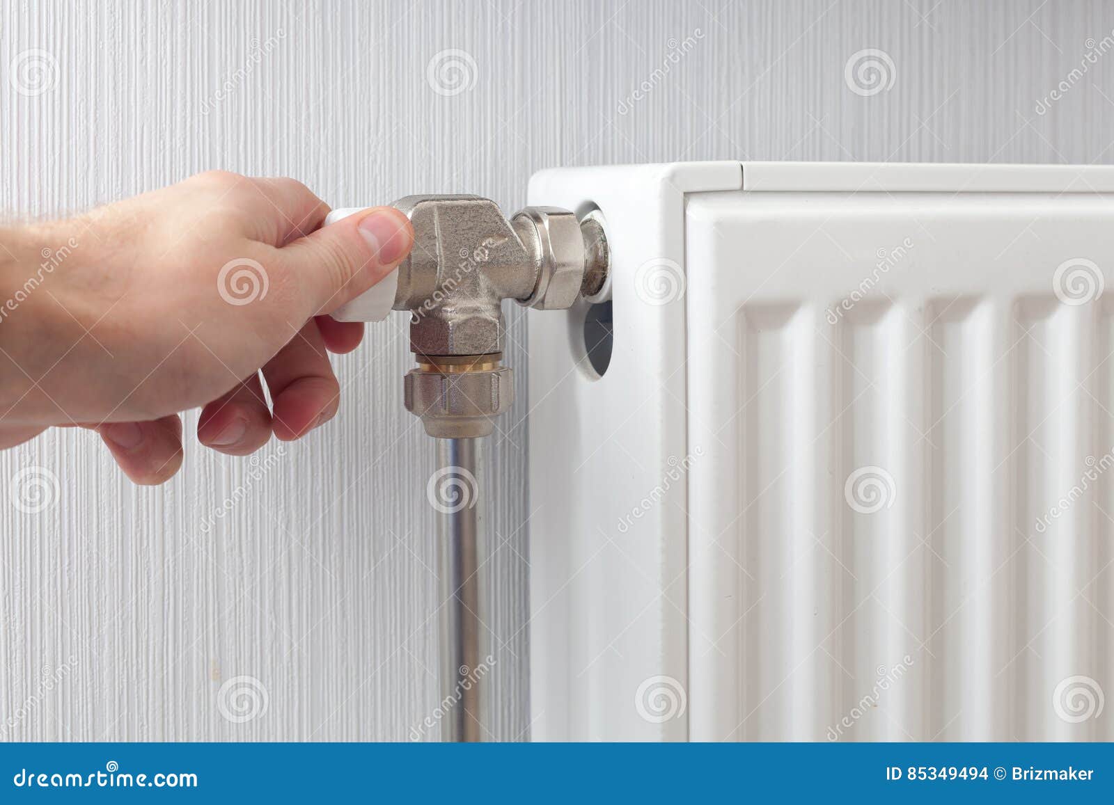 Radiator Adjustment Closeup. Man`s Hand Adjusting Radiator Temperature ...