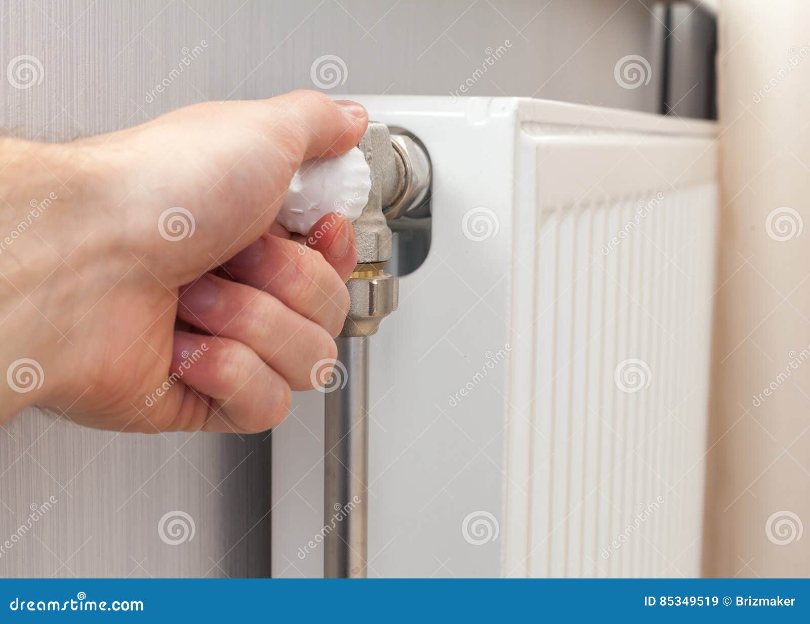 Radiator Adjustment Closeup. Man`s Hand Adjusting Radiator Temperature ...