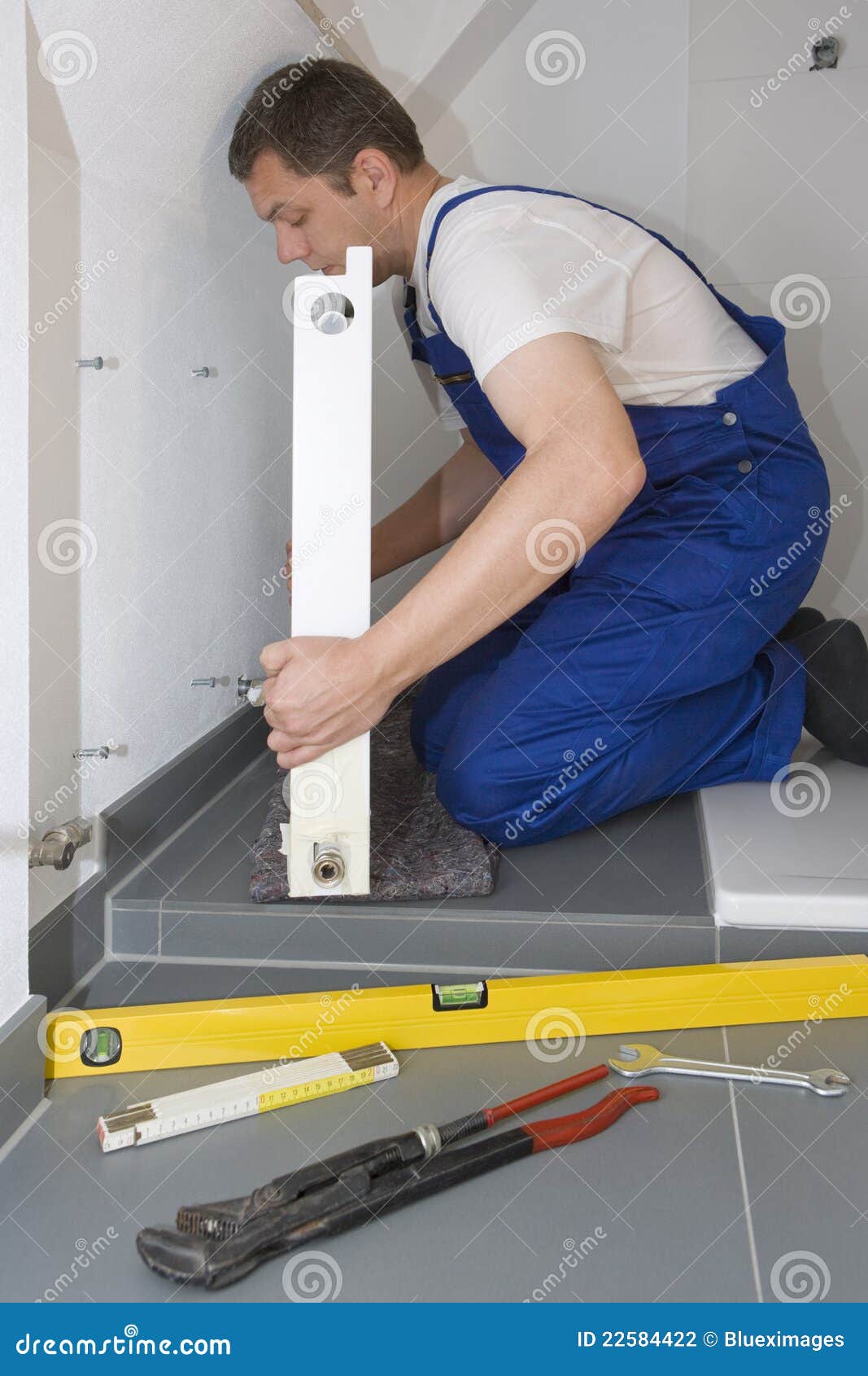Radiator installation stock photo. Image of fitter, building - 22584422