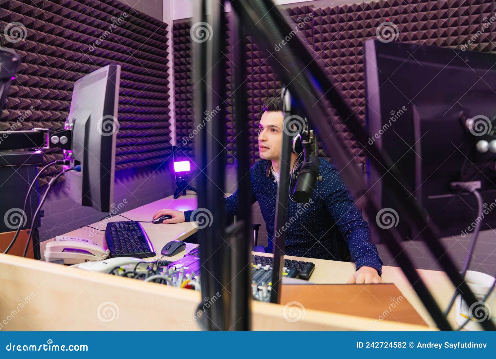 A Radio Host Conducts a Live Broadcast in a Professional Radio Studio ...
